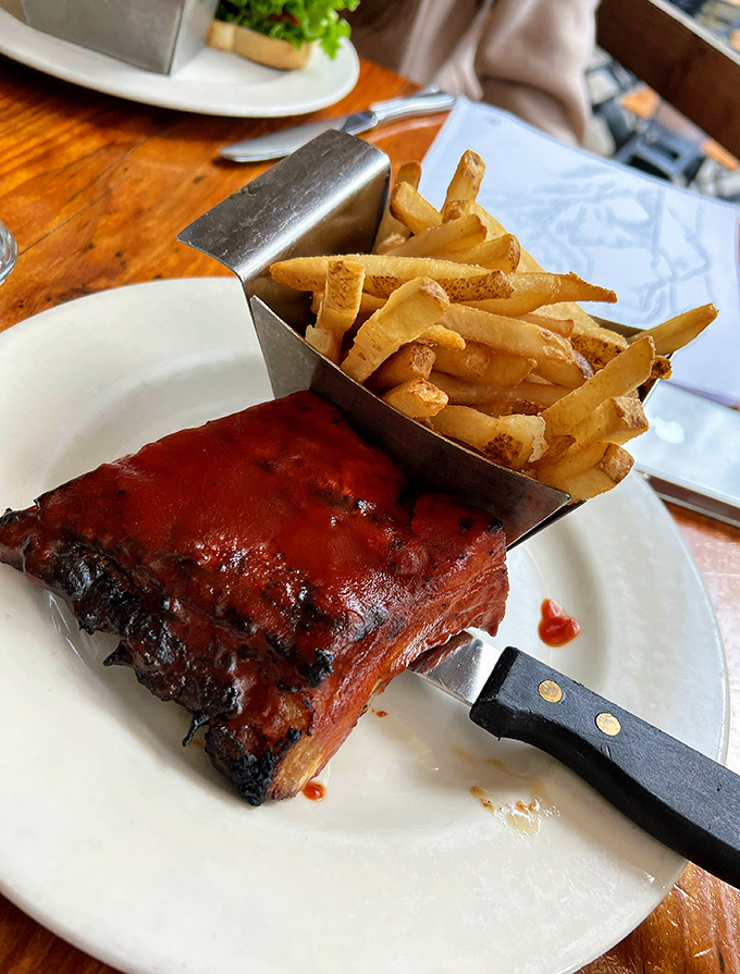 BBQ ribs so tender they practically surrender to your fork. The sauce-to-meat ratio here is what mathematicians call "perfect harmony."