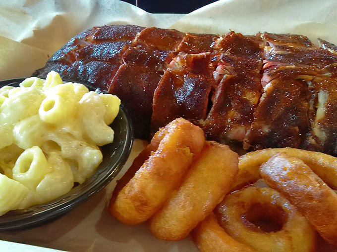 Behold the holy trinity of Southern comfort: fall-off-the-bone ribs, creamy mac and cheese, and golden onion rings that crunch like autumn leaves.