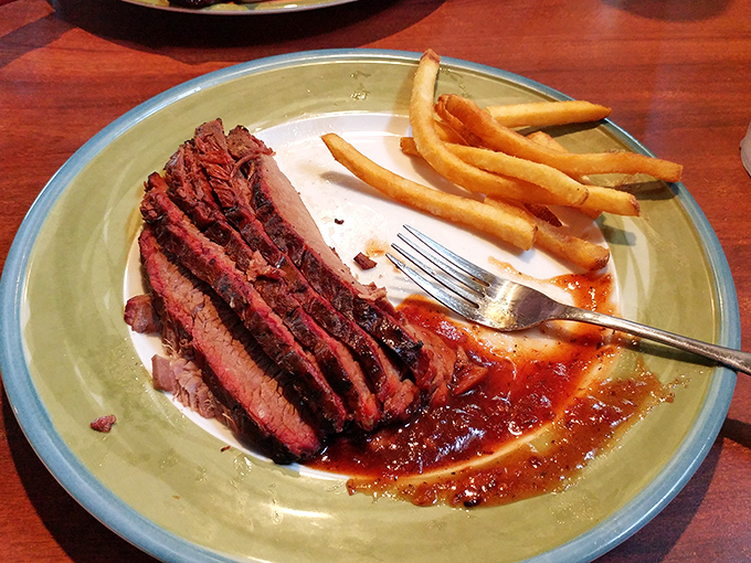 Behold the brisket – that pink smoke ring is the barbecue equivalent of a Michelin star. Those French fries are just along for the glorious ride.