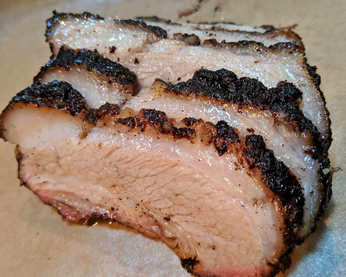 Behold the brisket in all its glory – that perfect pink smoke ring and rendered fat cap is the barbecue equivalent of finding the Holy Grail.