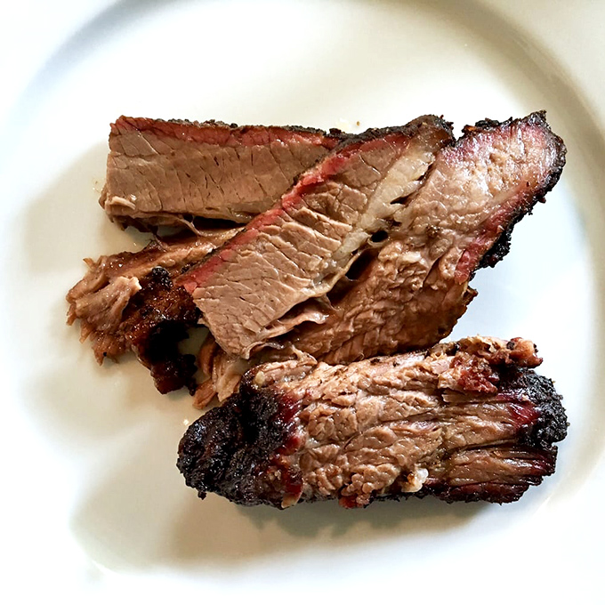 Brisket so perfectly rendered it practically dissolves on contact. That bark is the result of patience, not shortcuts.