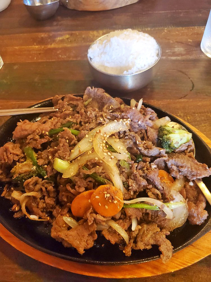 Sizzling beef bulgogi arrives like a rockstar on stage &ndash; tender meat, caramelized vegetables, and a side of fluffy rice ready for their standing ovation.