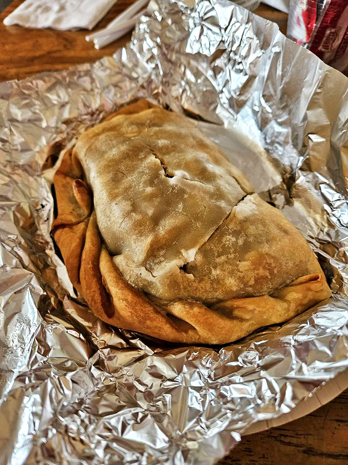 The star of the show: a golden-brown beef pasty nestled in foil, ready to transport you to Upper Peninsula paradise.