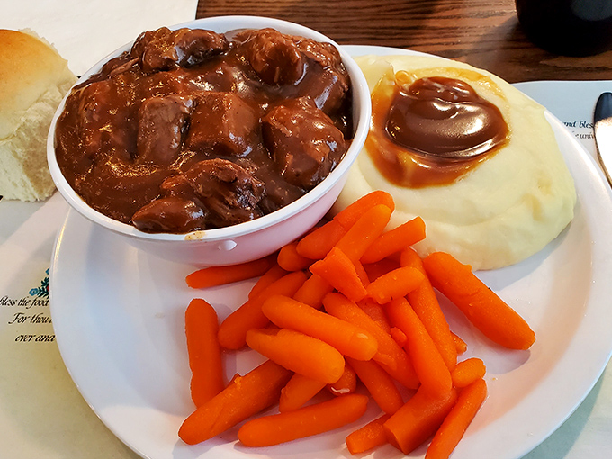 Beef tips swimming in gravy like they've found their forever home, with mashed potatoes playing perfect supporting actor.