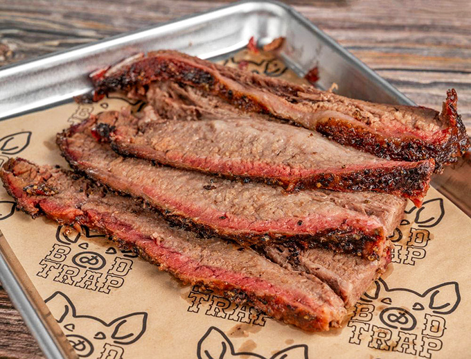 Behold the brisket in all its bark-encrusted glory. Those pink smoke rings aren't just pretty &ndash; they're edible badges of honor earned through hours of patient smoking.