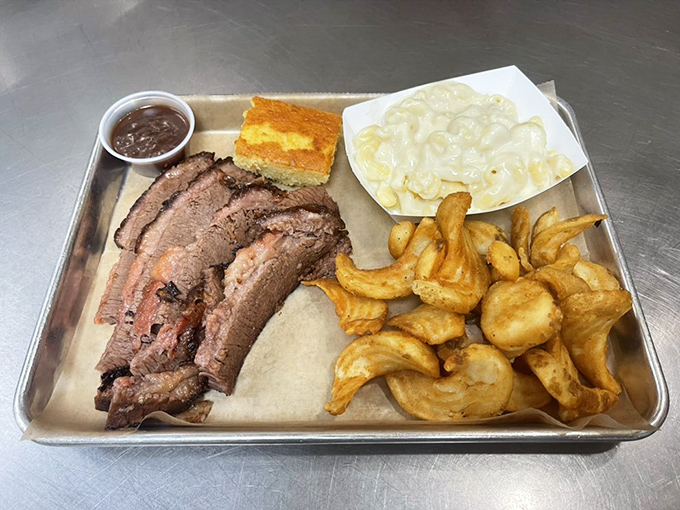 Brisket that would make a Texan weep with joy, paired with mac and cheese that's unapologetically creamy and curly fries.