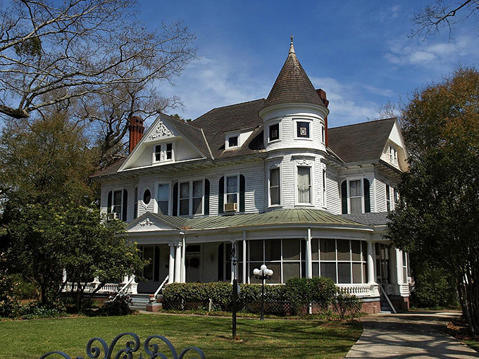 This magnificent Victorian home with its distinctive turret and wraparound porch embodies Southern architectural elegance at its finest.
