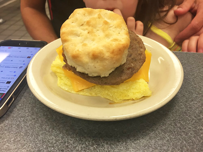 Breakfast architecture at its finest&mdash;a golden biscuit, savory sausage, melted cheese, and fluffy egg stacked with the precision of a breakfast Jenga master