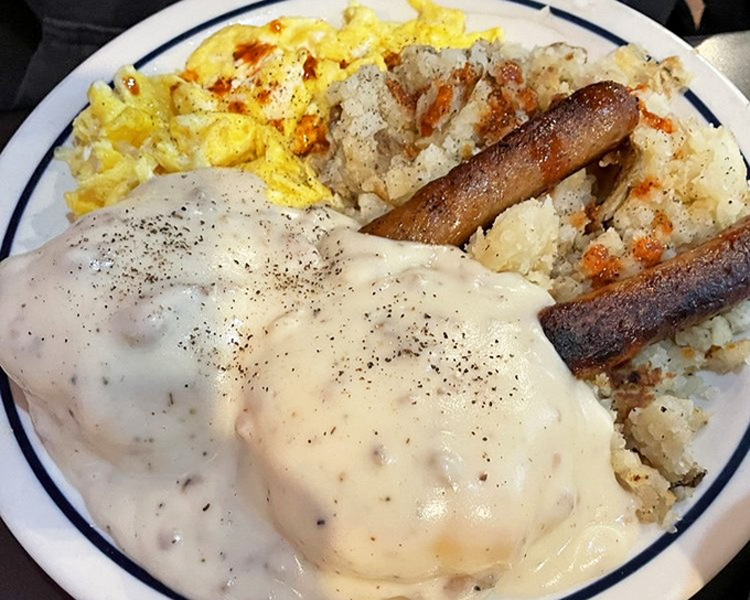 Behold the holy grail of comfort food &ndash; biscuits drowning in peppery sausage gravy alongside perfectly scrambled eggs and crispy hash browns.