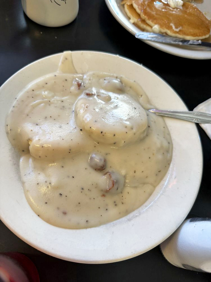 Behold the star attraction: biscuits drowning in creamy, peppery gravy studded with sausage chunks. Worth crossing state lines for this plate of comfort.