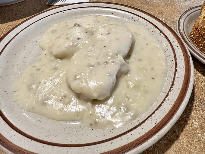 Behold the star of our show: biscuits drowning happily in creamy, pepper-flecked gravy. If clouds were edible and made of butter and love, they'd taste exactly like this.