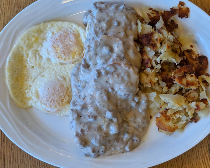 Biscuits and gravy that would make your Southern grandmother weep with joy, accompanied by eggs and home fries that refuse to be upstaged.