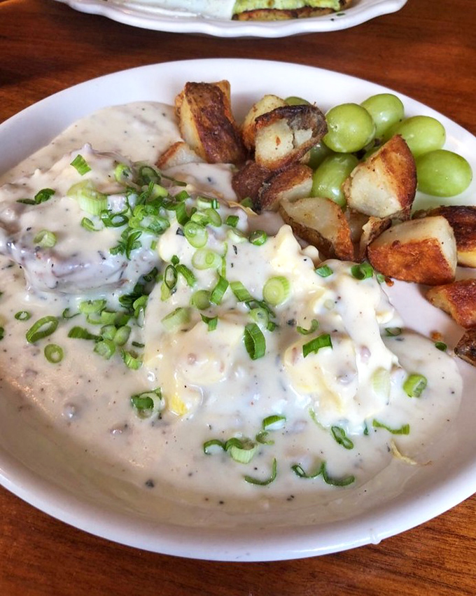 Behold the legendary biscuits and gravy&mdash;a velvety blanket of sausage gravy atop scrambled eggs, with crispy potatoes and grapes providing perfect counterpoints. 