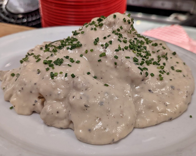Behold the holy grail of comfort food&mdash;biscuits drowning in peppery country gravy, sprinkled with chives that add color but know their supporting role.