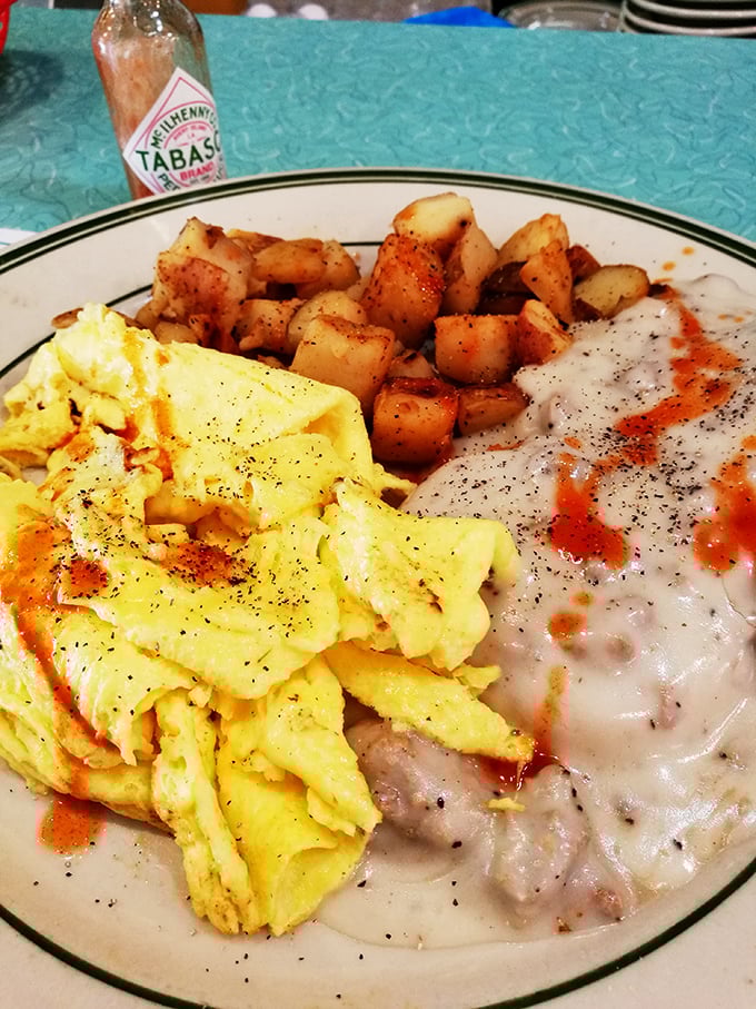 Breakfast nirvana: fluffy scrambled eggs, perfectly seasoned home fries, and country gravy that would make your Southern grandmother nod in approval.