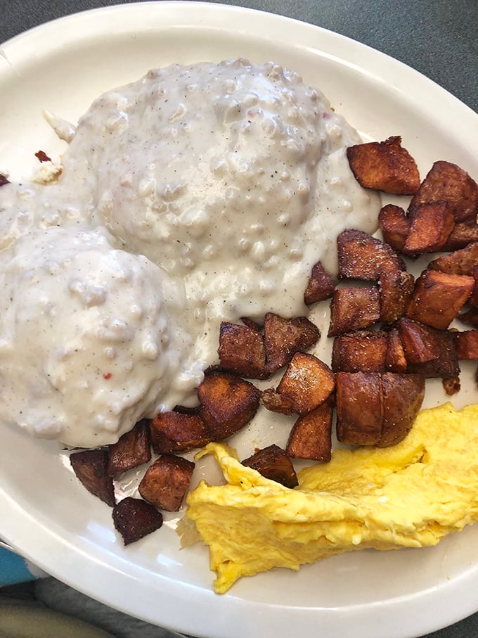 Biscuits and gravy that make you question every other version you've ever had. Those home fries look like they've achieved the perfect crisp-to-tender ratio&mdash;the holy grail of potato preparation.