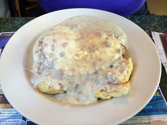 Behold the star attraction: biscuits drowning happily in creamy sausage gravy. This plate should come with a warning label and a nap schedule.