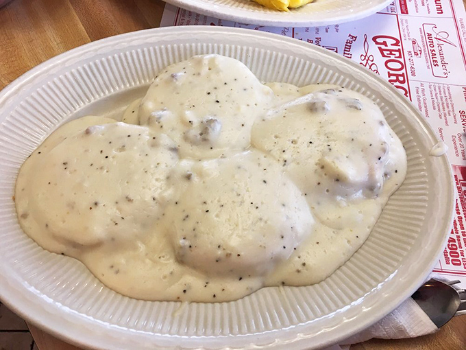 Behold the holy grail of comfort food! Flaky biscuits swimming in peppery sausage gravy &ndash; a plate that whispers, "Go back to bed after this."