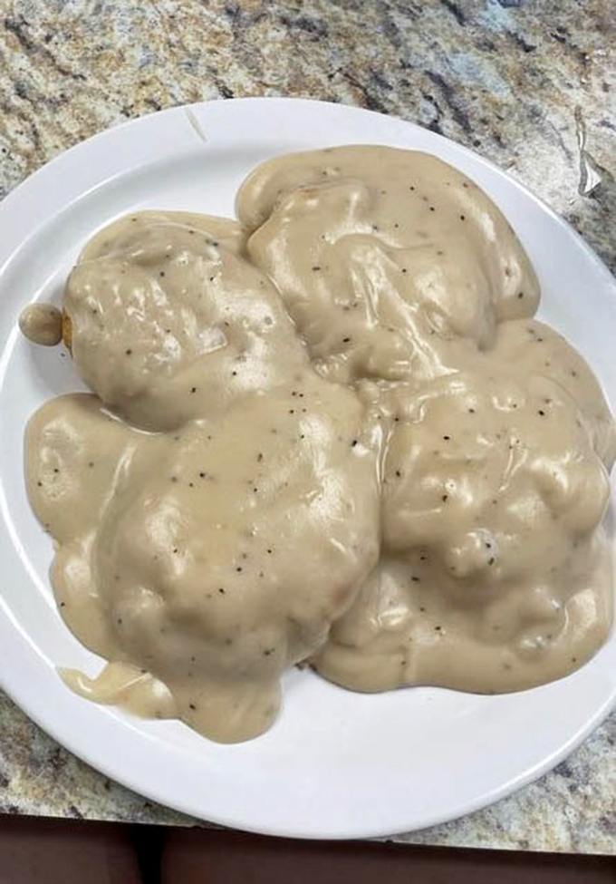 These biscuits and gravy aren't just a meal&mdash;they're a masterpiece of Southern comfort that makes you want to hug the chef and steal the recipe.