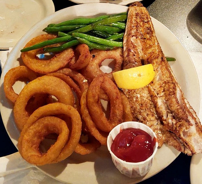 The blackened walleye arrives like a flavor ambassador from Lake Erie &ndash; perfectly seasoned, flaky, and flanked by golden onion rings that demand attention.