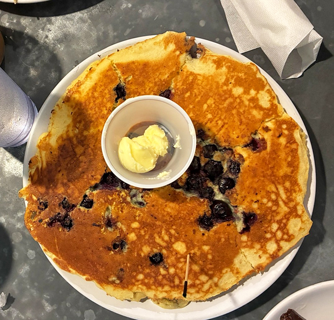 Blueberry pancakes that could make a maple tree jealous, with butter melting into golden perfection.