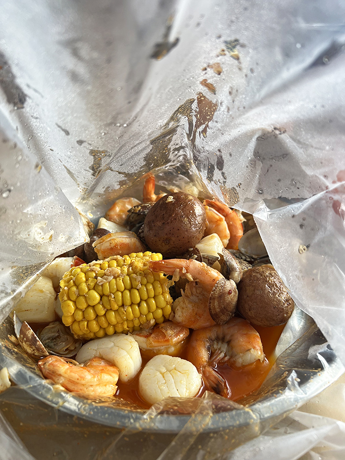 Behold the steaming bag of oceanic treasures that turns civilized diners into happy, sauce-covered shell-cracking warriors.