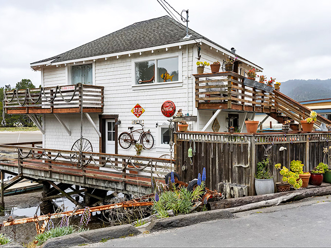 This weathered beach house tells stories of coastal living—vintage signs, potted plants, and that bicycle that's probably seen more sunsets than most people.