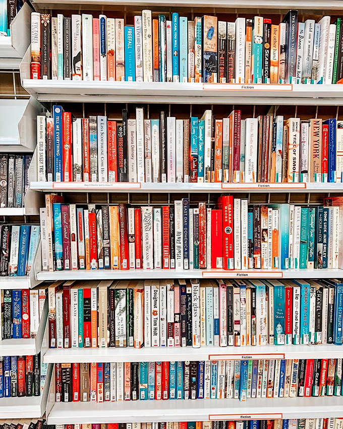 The fiction section houses thousands of literary journeys for less than a coffee. Some books arrive with beach sand still between their pages.