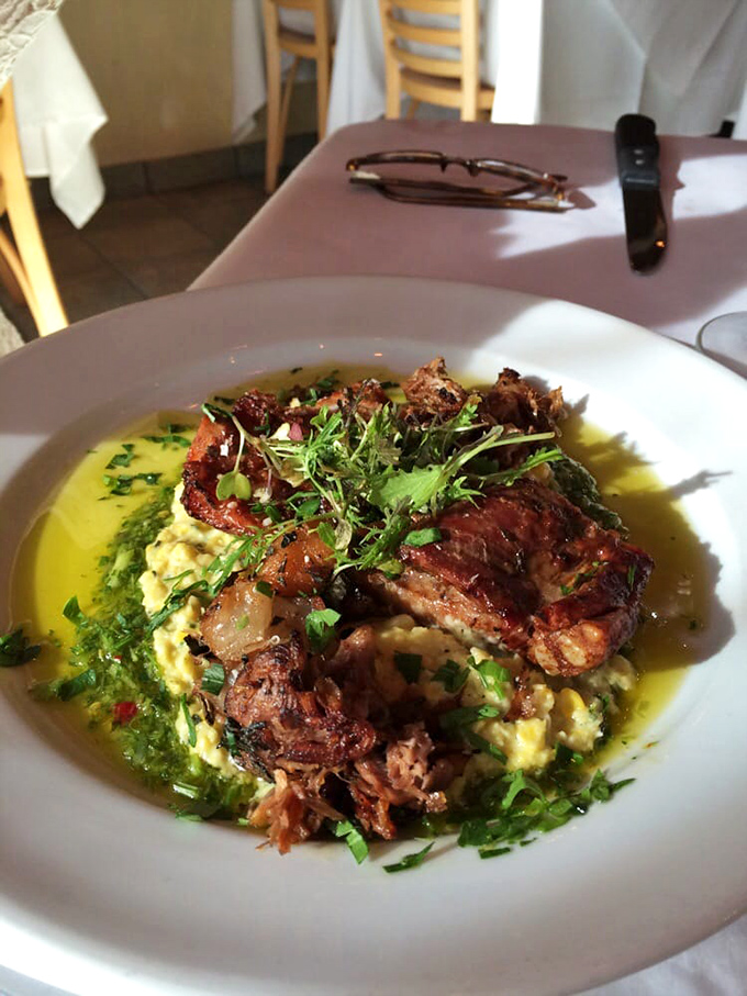 The star of the show: braised short ribs resting on creamy risotto, surrounded by a pool of savory jus. Fork-tender meat that's worth every calorie.