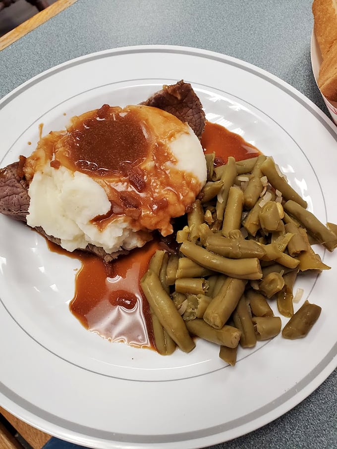 Mashed potatoes and gravy pooling into a tender steak with green beans on the side&mdash;a plate that whispers, "Everything's going to be okay."