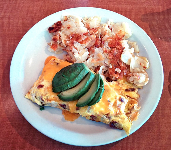 This omelet doesn't just come with avocado&mdash;it practically celebrates it, alongside hash browns so perfectly crispy they deserve their own fan club.