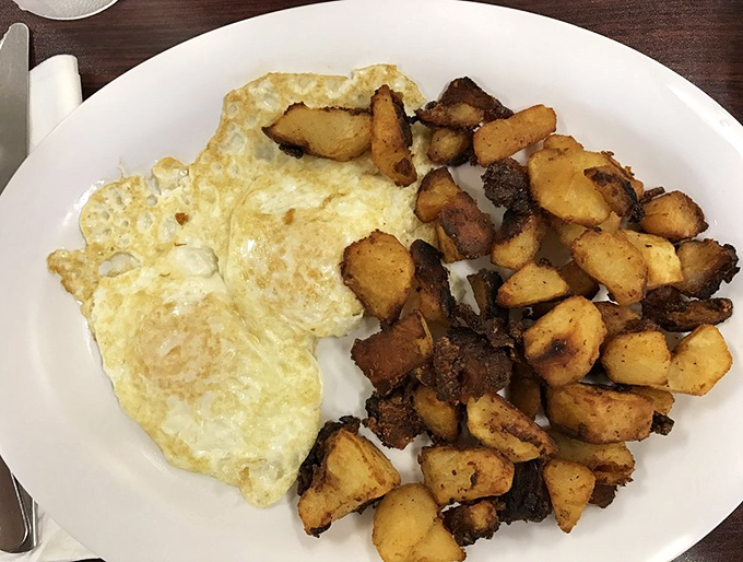 Sunny-side up eggs with perfectly crisped home fries—the breakfast equivalent of a perfect high-five to start your day. Simple, satisfying, sublime.