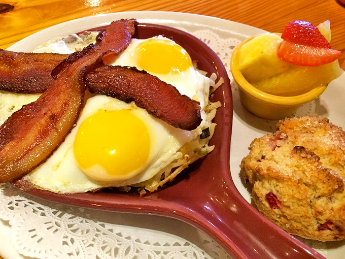 Breakfast perfection on a warm skillet &ndash; crispy bacon, sunny-side-up eggs, and a scone that could make a British baker weep with joy.