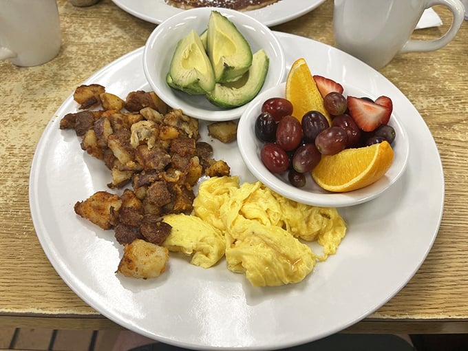Breakfast perfection: scrambled eggs that look like clouds, home fries with a perfect crisp, and fresh fruit that didn't come from a can.