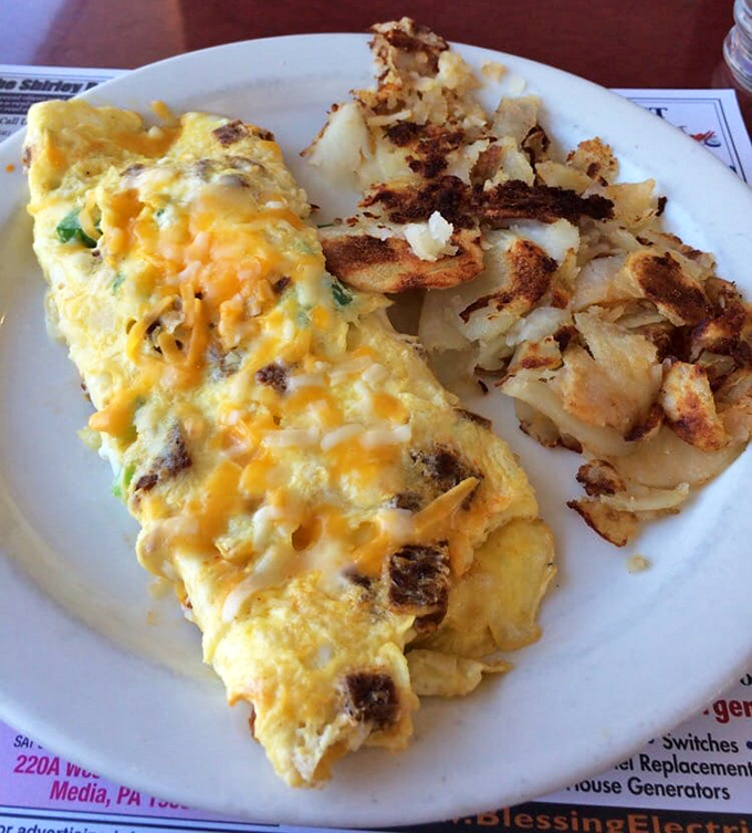 This cheese-laden omelette with perfectly crispy home fries might just be the breakfast equivalent of winning the lottery without having to share the ticket.