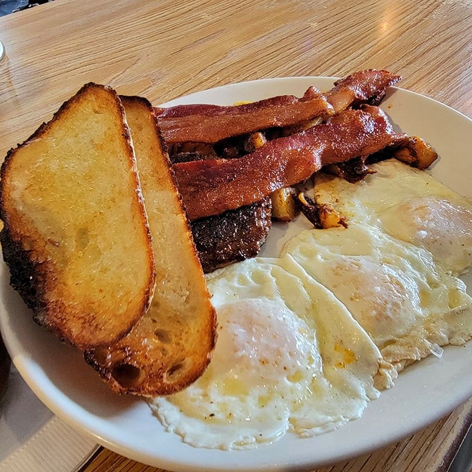 Perfect eggs and crispy bacon prove that sometimes simplicity creates the most satisfying symphonies.