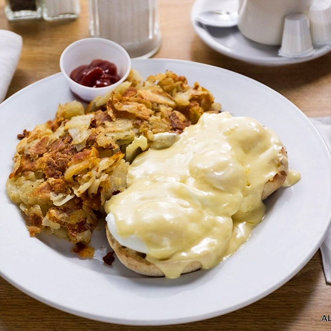 Eggs Benedict with crispy hash browns &ndash; where hollandaise dreams come true. The perfect marriage of creamy and crispy on one heavenly plate.