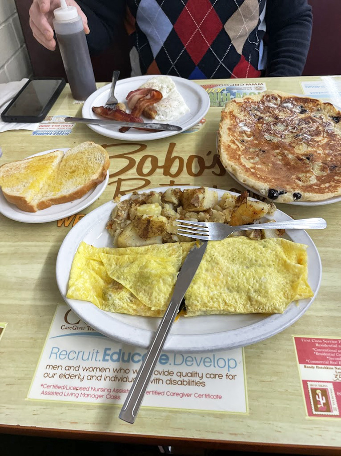 Breakfast symphony in four movements: eggs folded like origami, home fries with perfect crisp edges, buttery toast, and a pancake that deserves its own zip code.