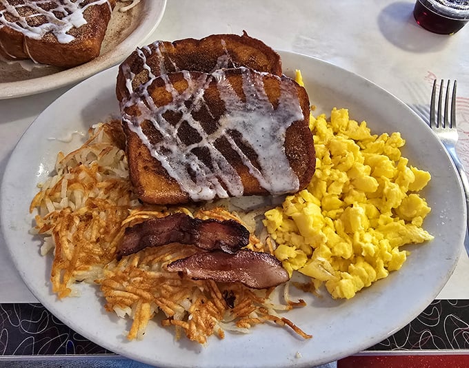 Breakfast perfection on a plate! Golden French toast, crispy hash browns, and scrambled eggs that would make your grandmother proud. Morning salvation, Arizona-style.
