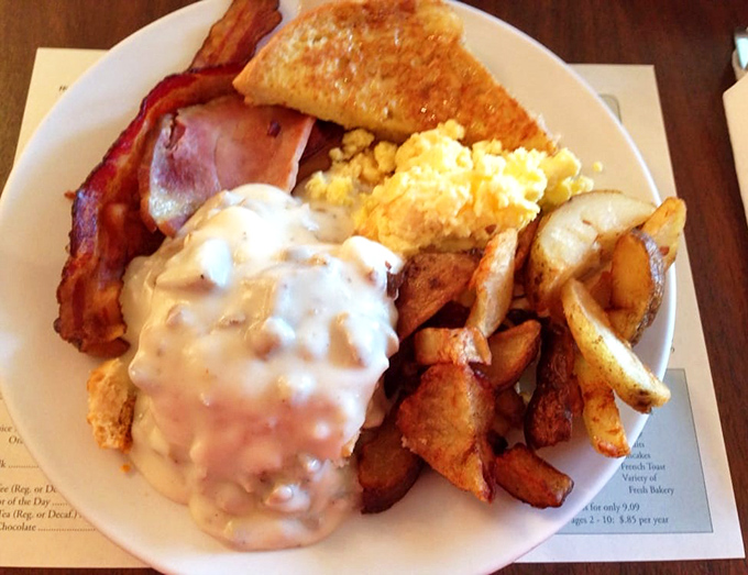 Breakfast nirvana achieved: golden home fries, fluffy eggs, and that sausage gravy could make a grown adult weep with joy.