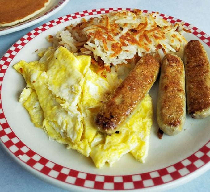 Breakfast perfection on a plate &ndash; golden eggs, crispy hash browns, and sausages that would make your cardiologist wince but your soul sing.