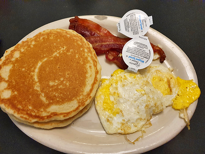 Golden pancake perfection meets crispy bacon and sunny-side-up eggs&mdash;the holy trinity of breakfast done right.