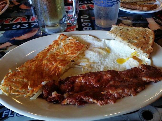 The breakfast trinity: perfectly crispy hash browns, eggs that actually respect your "over-medium" request, and bacon that would make a vegetarian question their life choices.