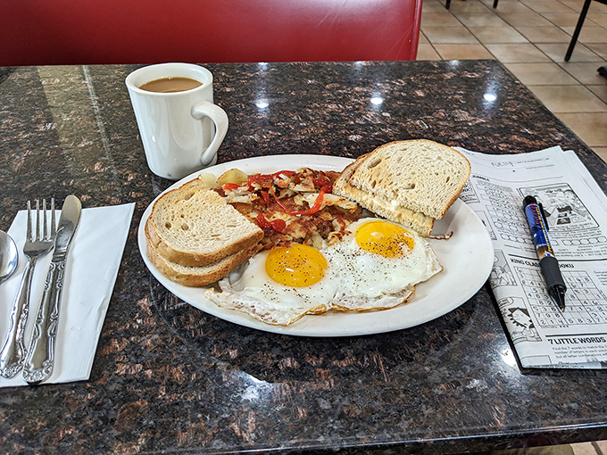 Two sunny-side up eggs flanking home fries that could make a potato farmer weep with pride.