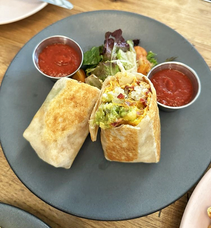 The breakfast burrito in its natural habitat &ndash; perfectly grilled, generously stuffed, and flanked by salsa roja that's practically begging to join the party.