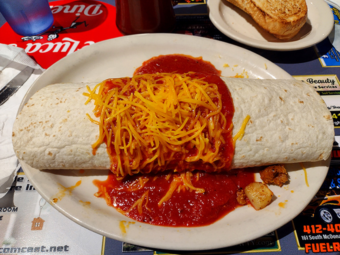 Behold the breakfast burrito that requires a game plan: smothered in salsa and cheese, it's the kind of morning commitment that renders lunch optional.
