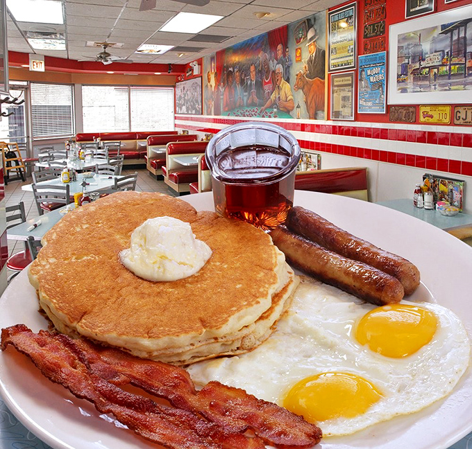 Breakfast perfection on a plate &ndash; golden pancakes, sunny eggs, and bacon that's achieved that mythical balance between crispy and chewy.