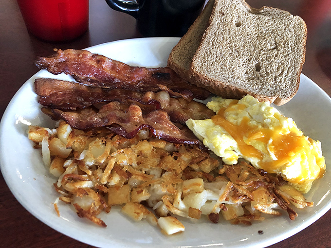 The holy trinity of breakfast: perfectly cooked eggs, crispy bacon, and hash browns that should win awards. Simple food executed with respect and skill.