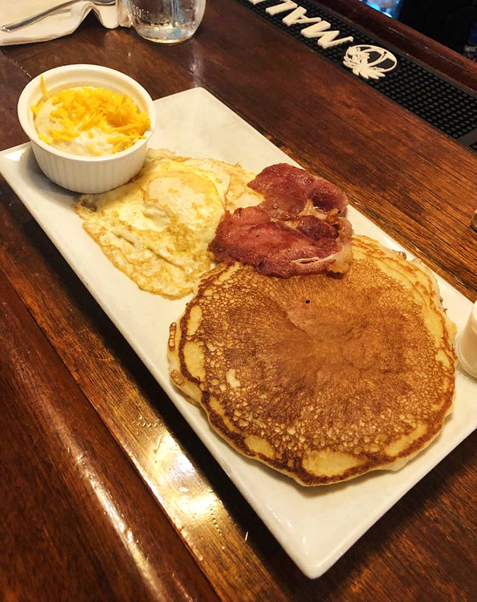 Golden pancakes that could make the sun jealous, paired with eggs and bacon that remind you why breakfast deserves its "most important meal" status.