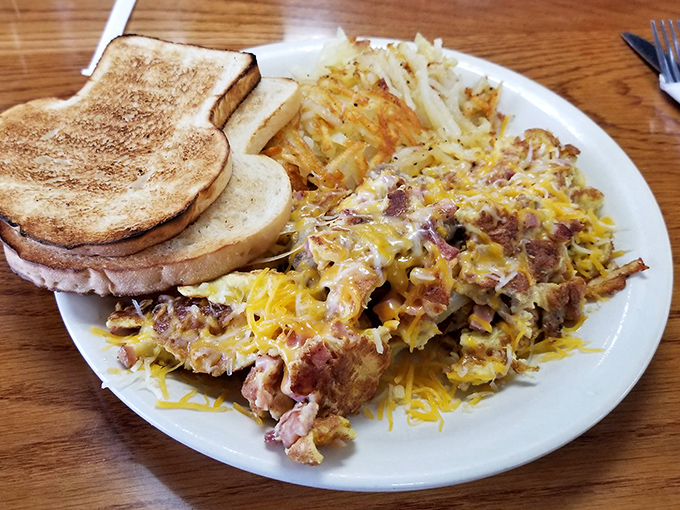 This isn't just breakfast&mdash;it's a masterpiece of morning indulgence with perfectly scrambled eggs, crispy hash browns, and toast that's achieved golden perfection.